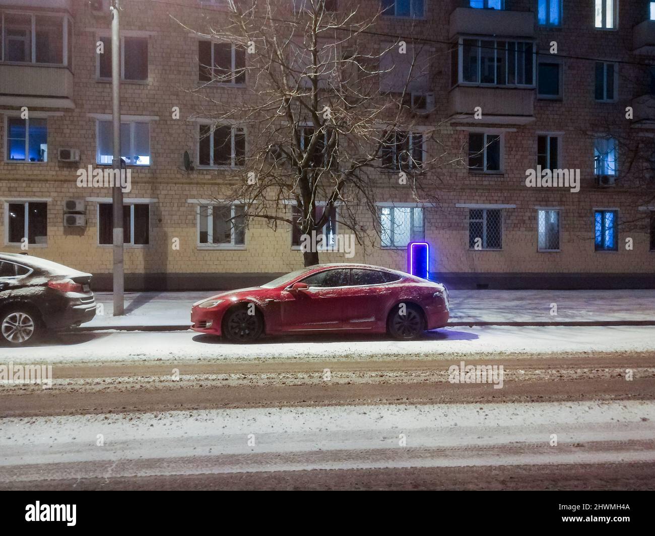 Moscow. Russia. November 30, 2021. A red Tesla car is charging a ...