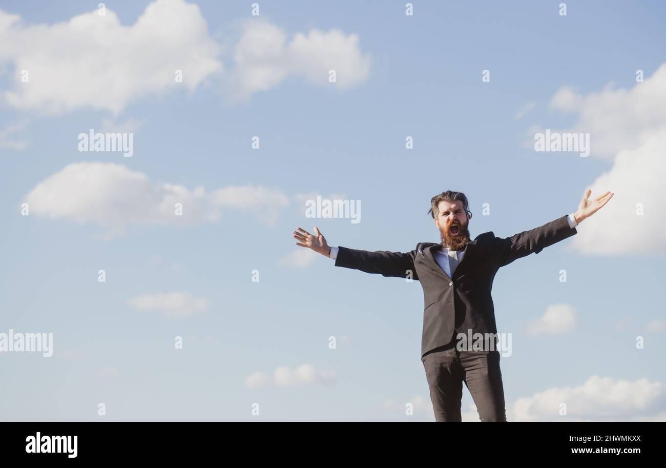 Man in suit raising hand on sky background. Freedom adventure and ...