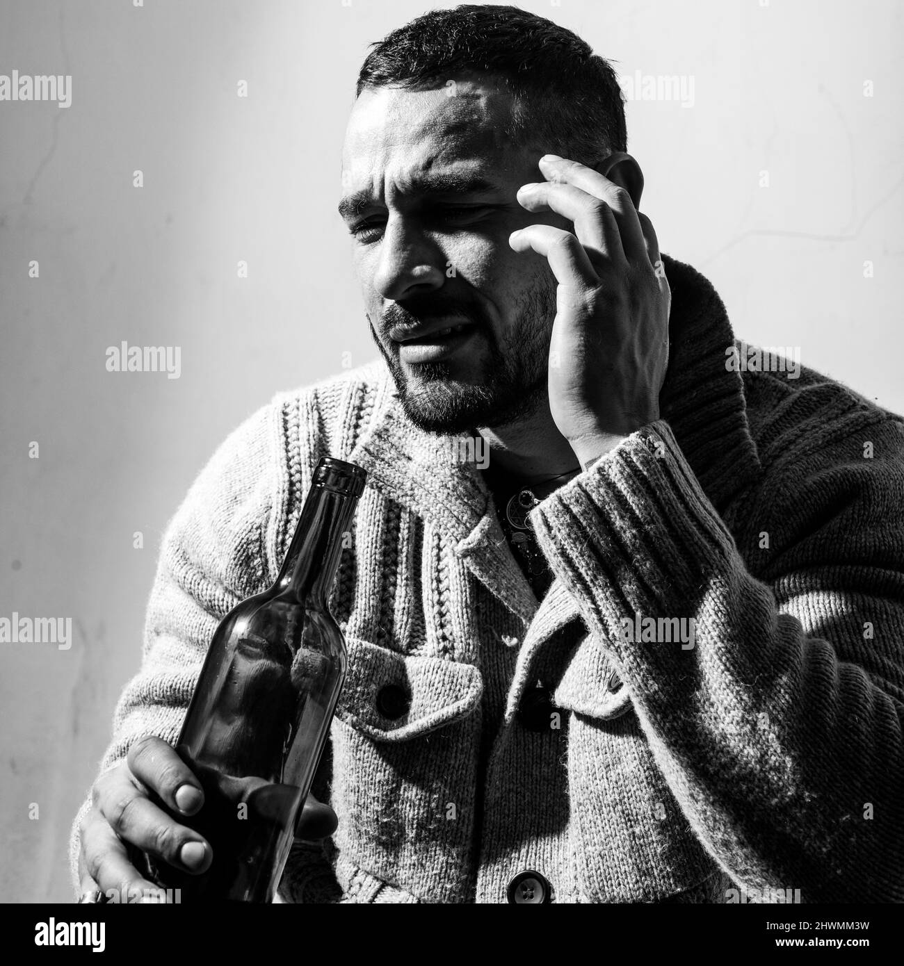 Alcoholic man with bottles wine cry. Depressed crying man. Drunk men ...