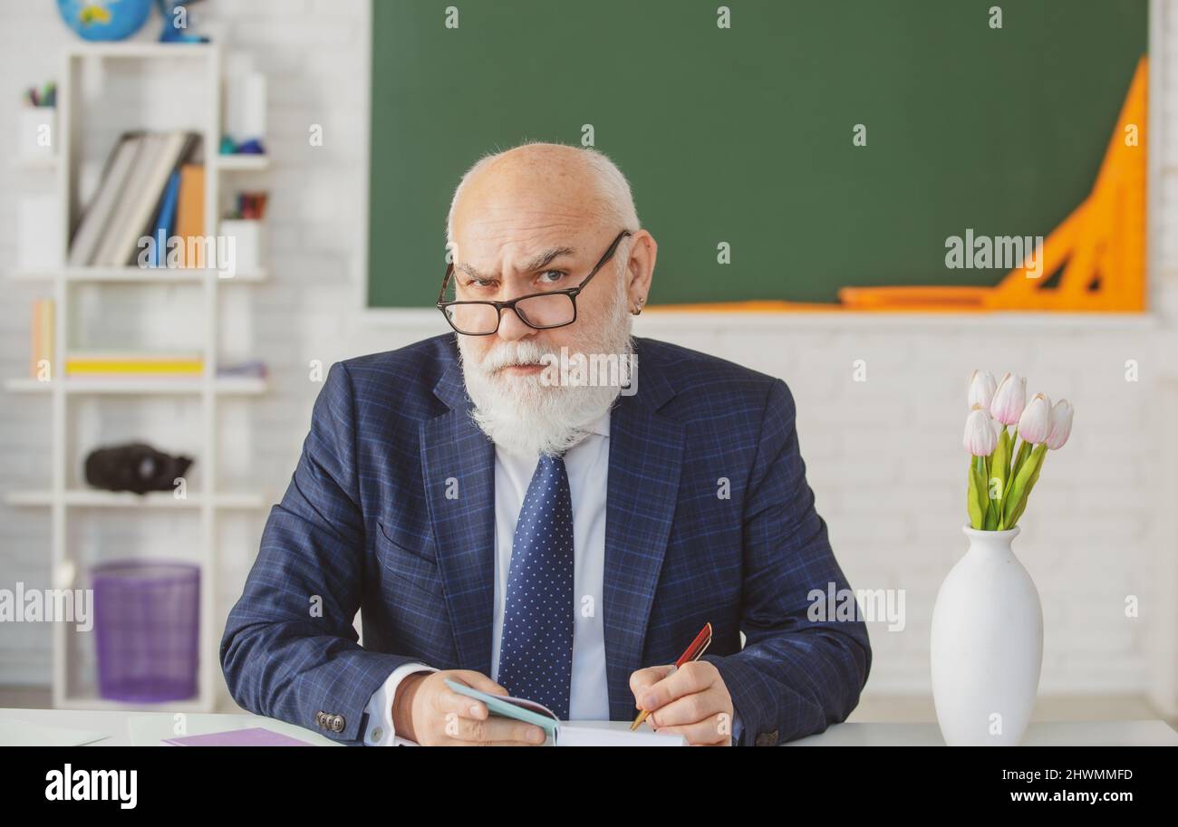 Professor holding a book and pointing with a wooden stick isolated on ...