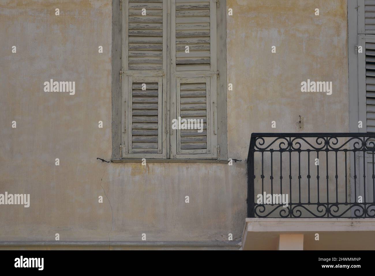 Old Neoclassical house facade with an antique wooden window and a ...