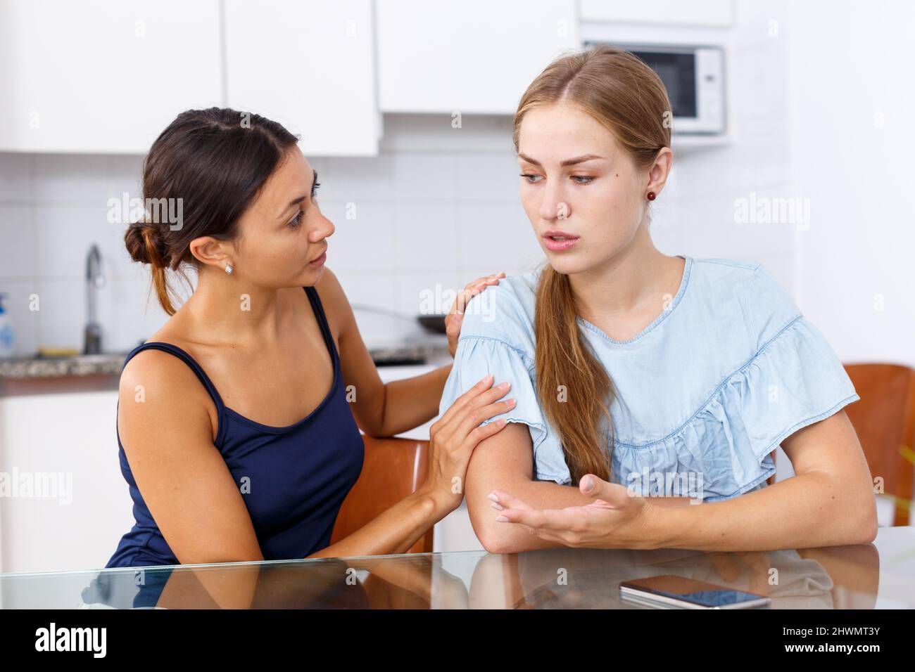 Woman trying to support her sad friend Stock Photo - Alamy