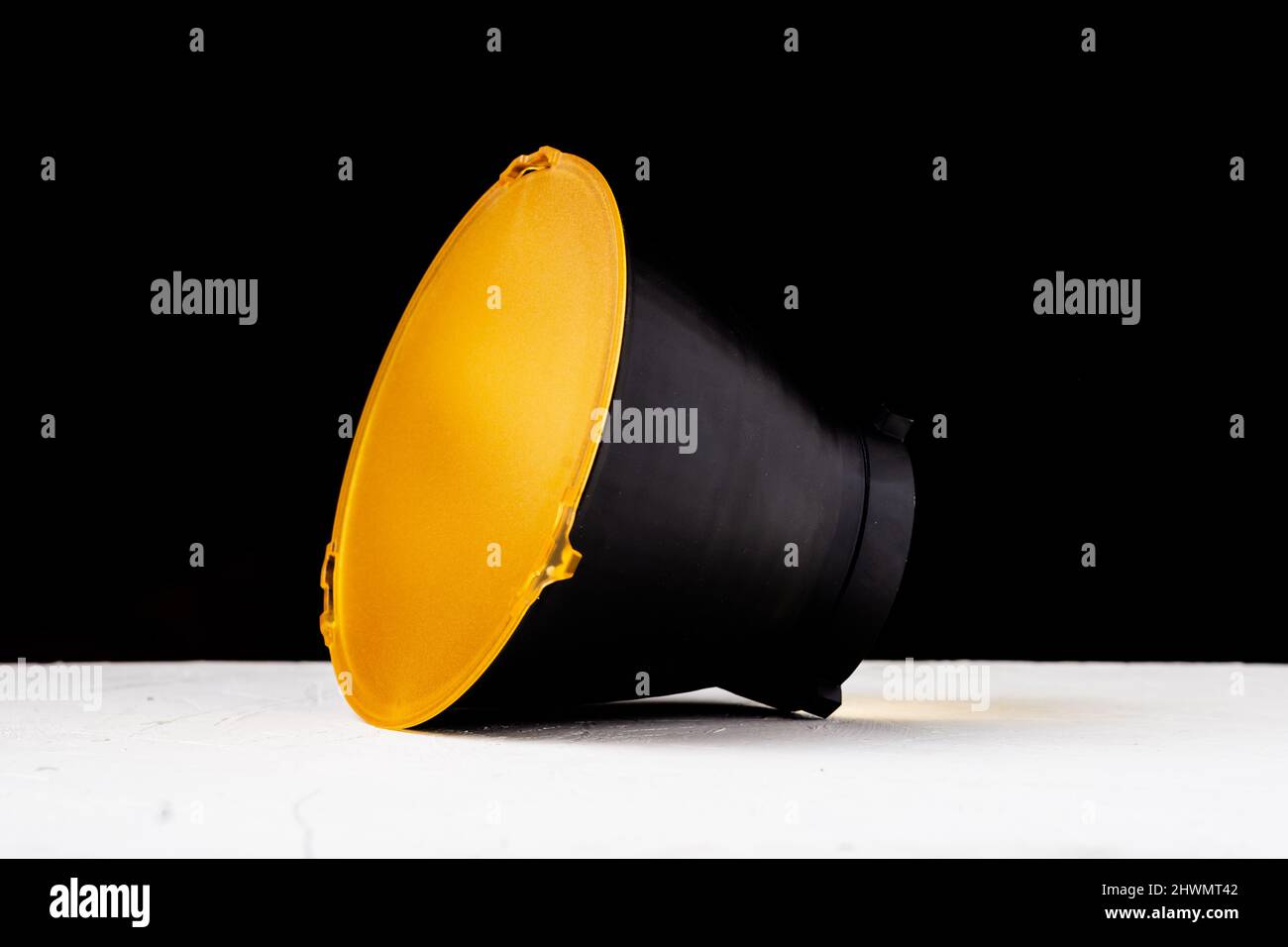 Standard reflector with a matte yellow diffuser on a black background ...