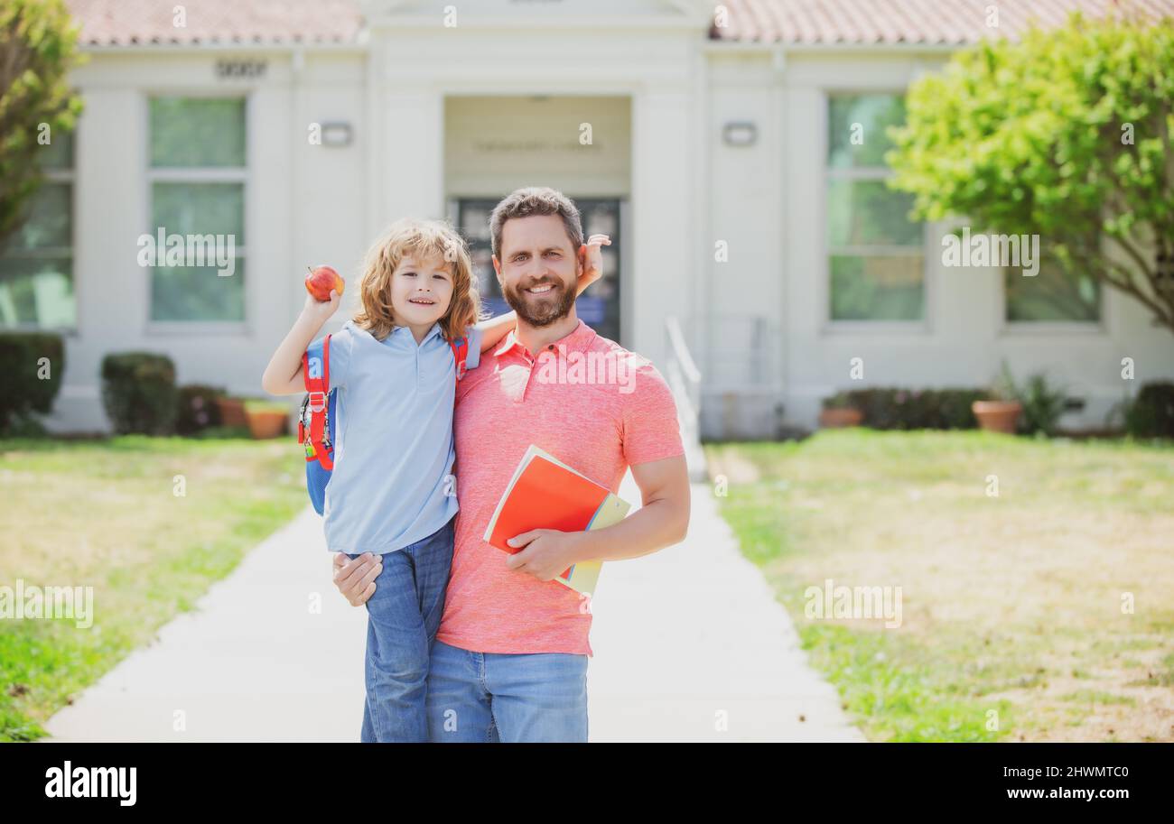 Father supports and motivates son. Kid going to primary school. Father ...