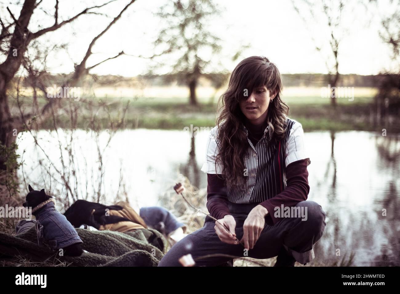 natural strong young woman by water roasting marshmallows Stock Photo ...