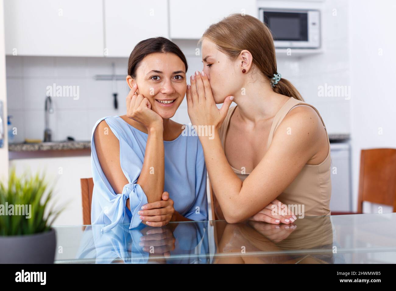 Young girl telling gossip her friend Stock Photo - Alamy