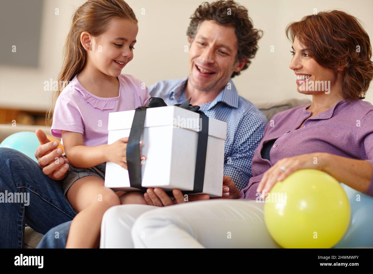 Family is a gift that lasts forever. Shot of a family siting in the ...