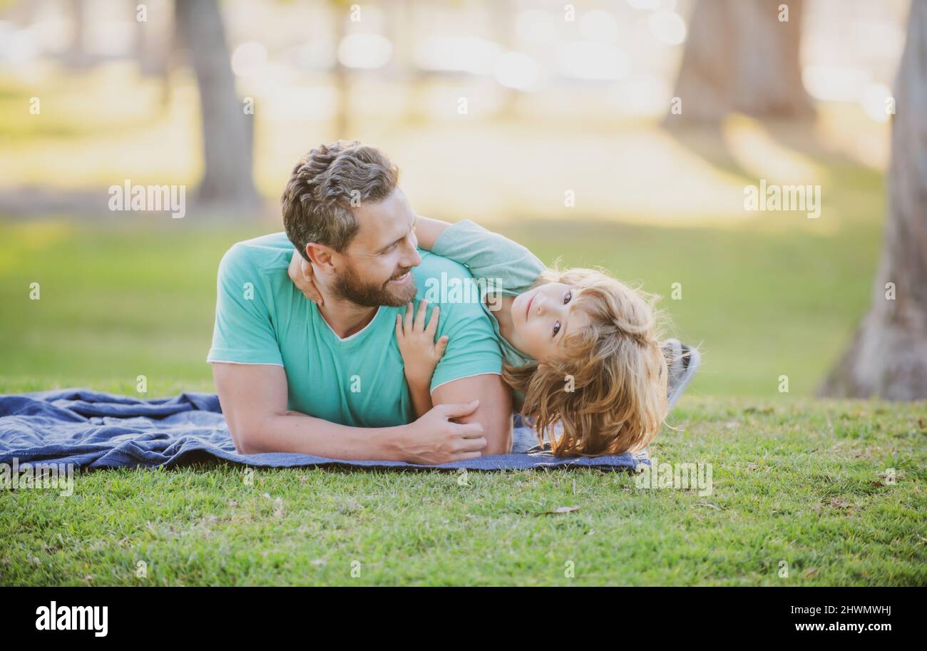 Father And Son Hugging And Playing Together In Green Nature Park