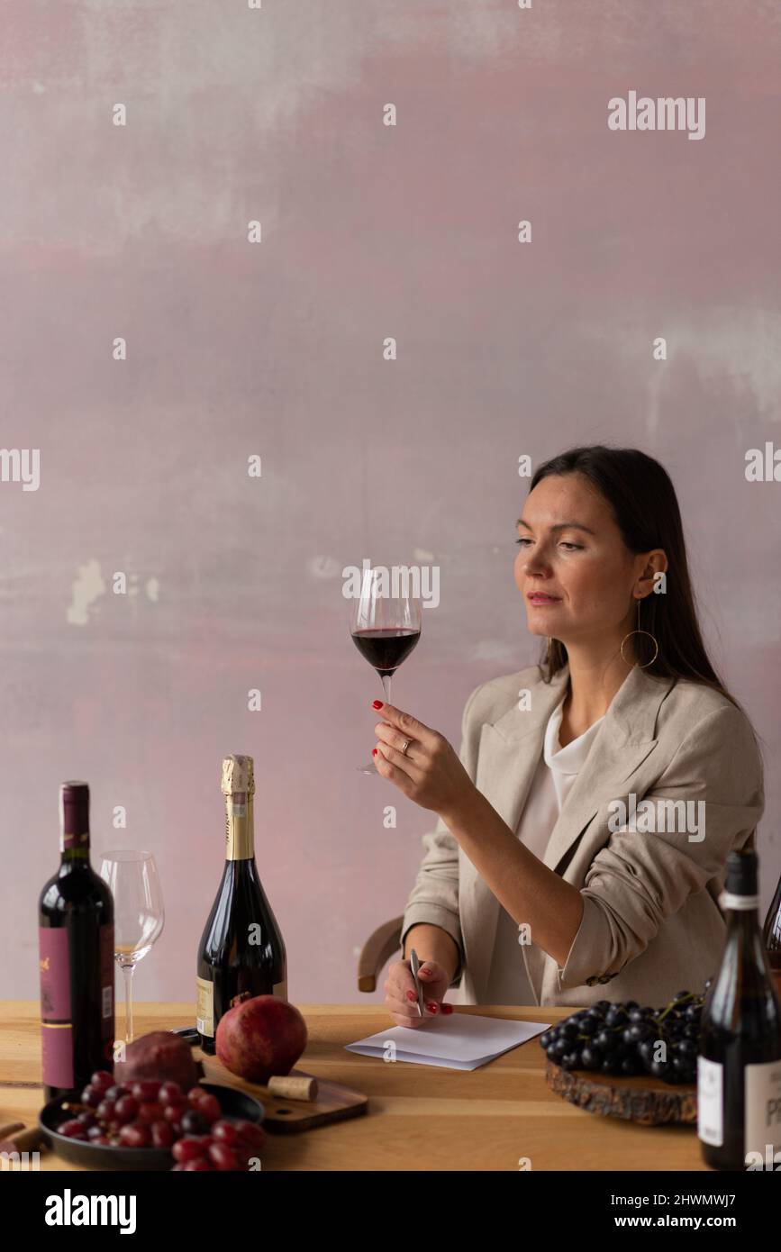 Brunette woman sommelier writing notes testing wine drink Stock Photo ... Brunette woman sommelier writing notes testing wine drink Stock Photo ...