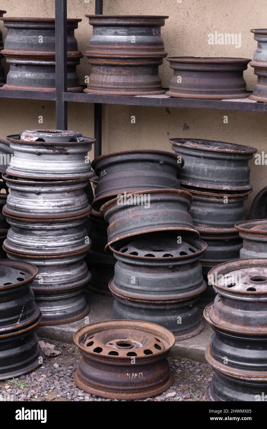 Old rusty metal car rims folded in a garage Stock Photo - Alamy