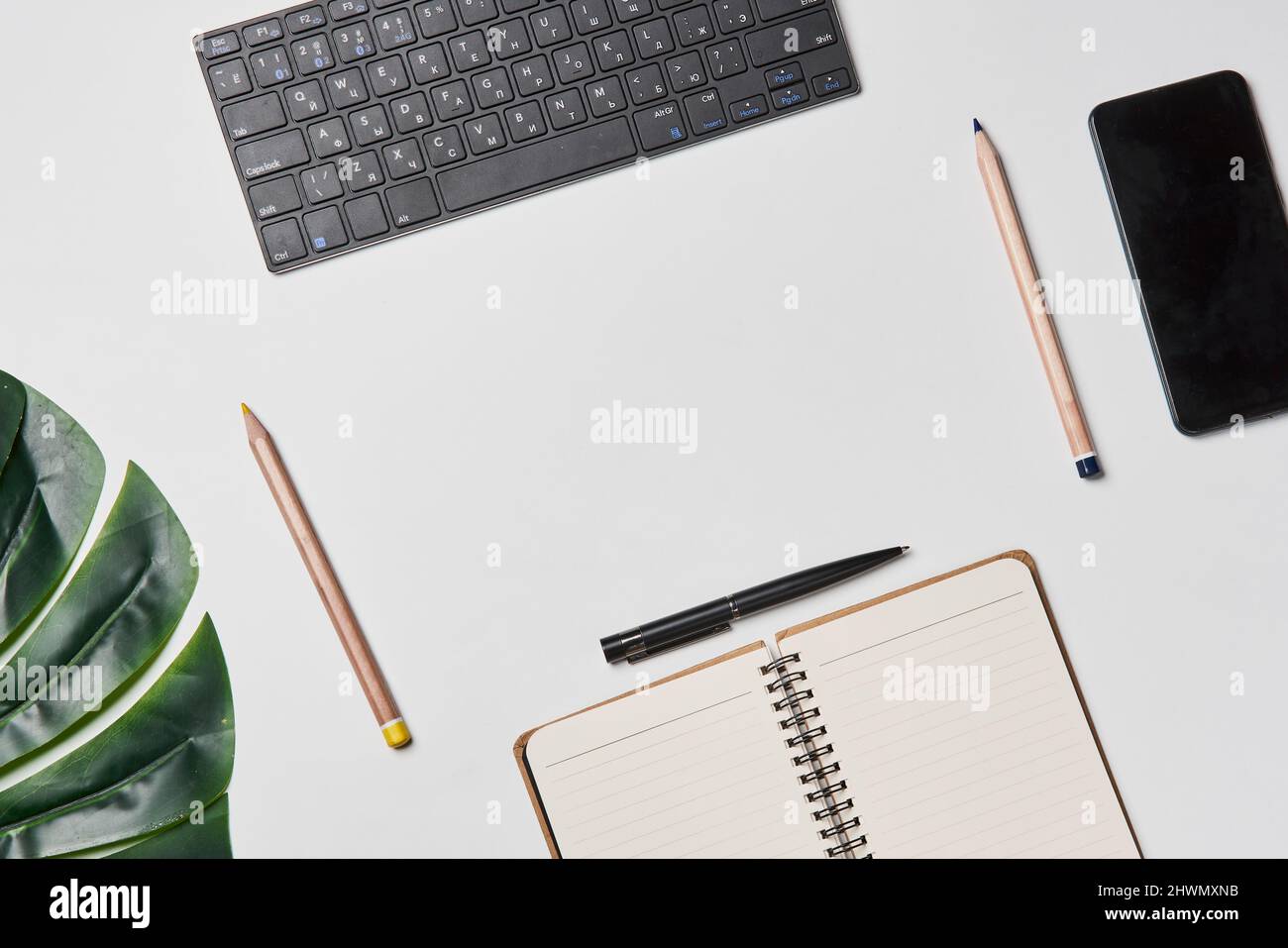 Bright office workspace. Work space with notepad, keyboard, coffee and ...