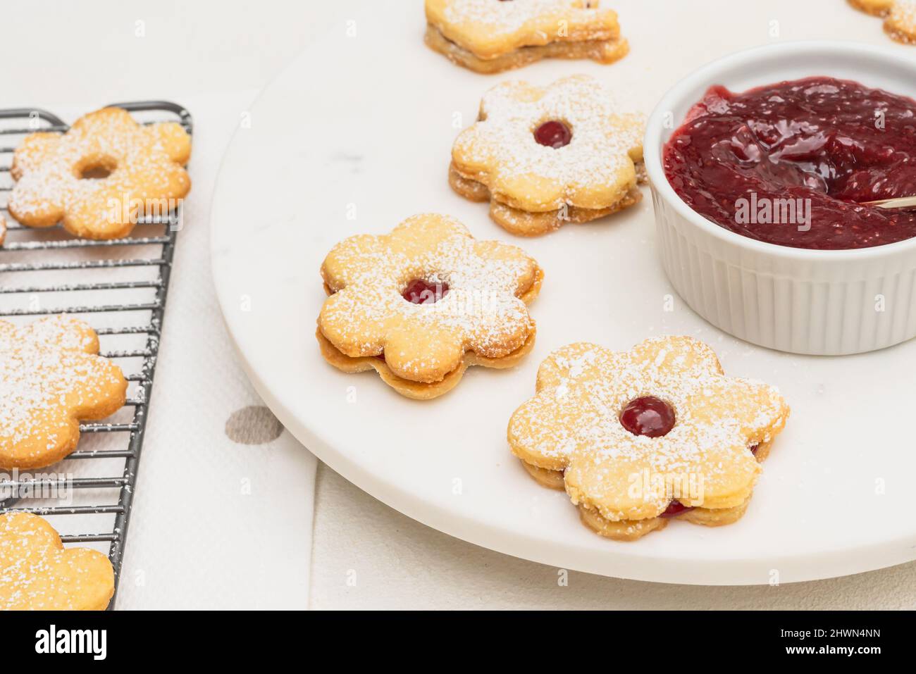 Flower shaped shortbread cookies filled with raspberry jam close up on ...