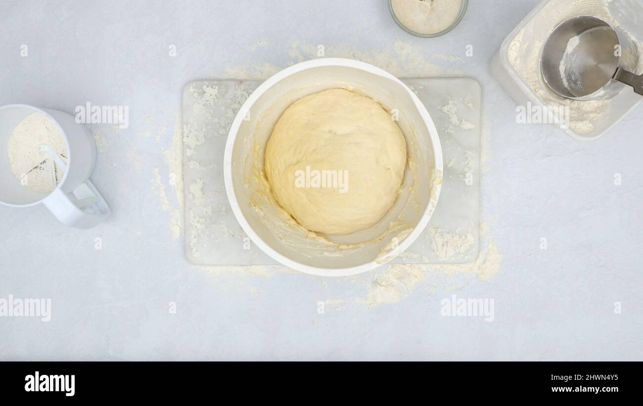 Raised bread dough in a bowl, view from above. Step by step cheese ...