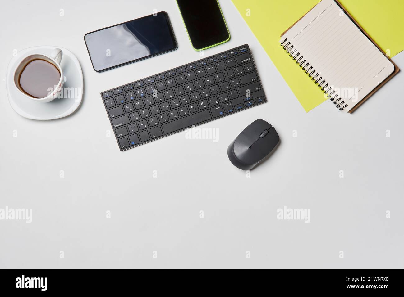 Bright office workspace. Work space with notepad, keyboard, coffee and ...