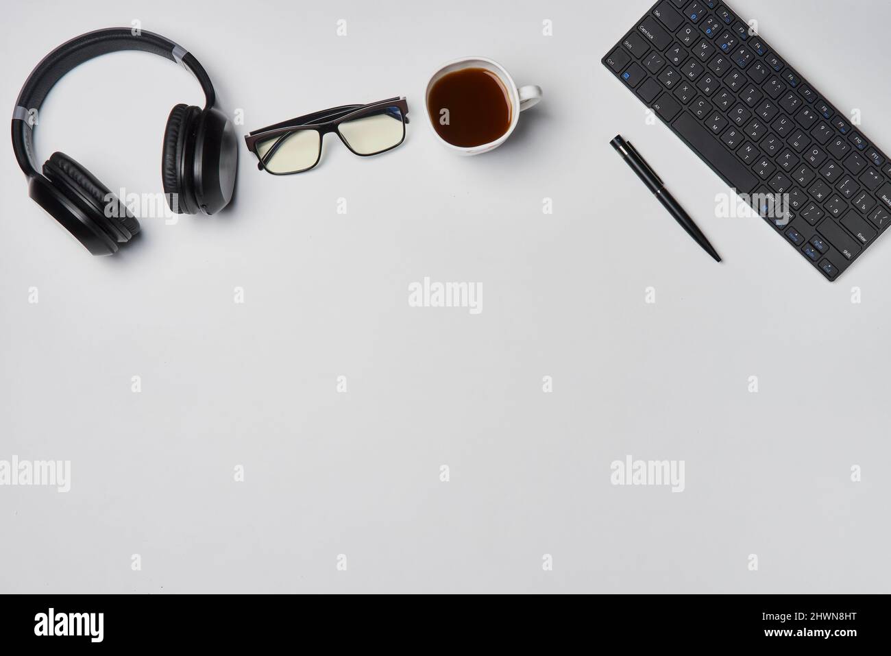 Bright office workspace. Work space with notepad, keyboard, coffee and ...