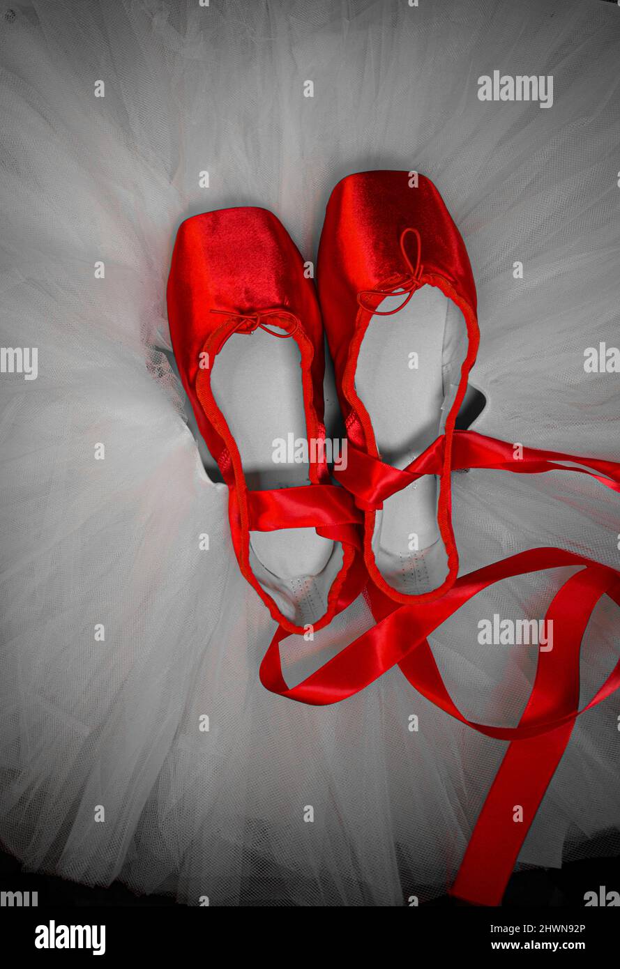 Red ballet pointe shoes set on top of a white tutu Stock Photo - Alamy