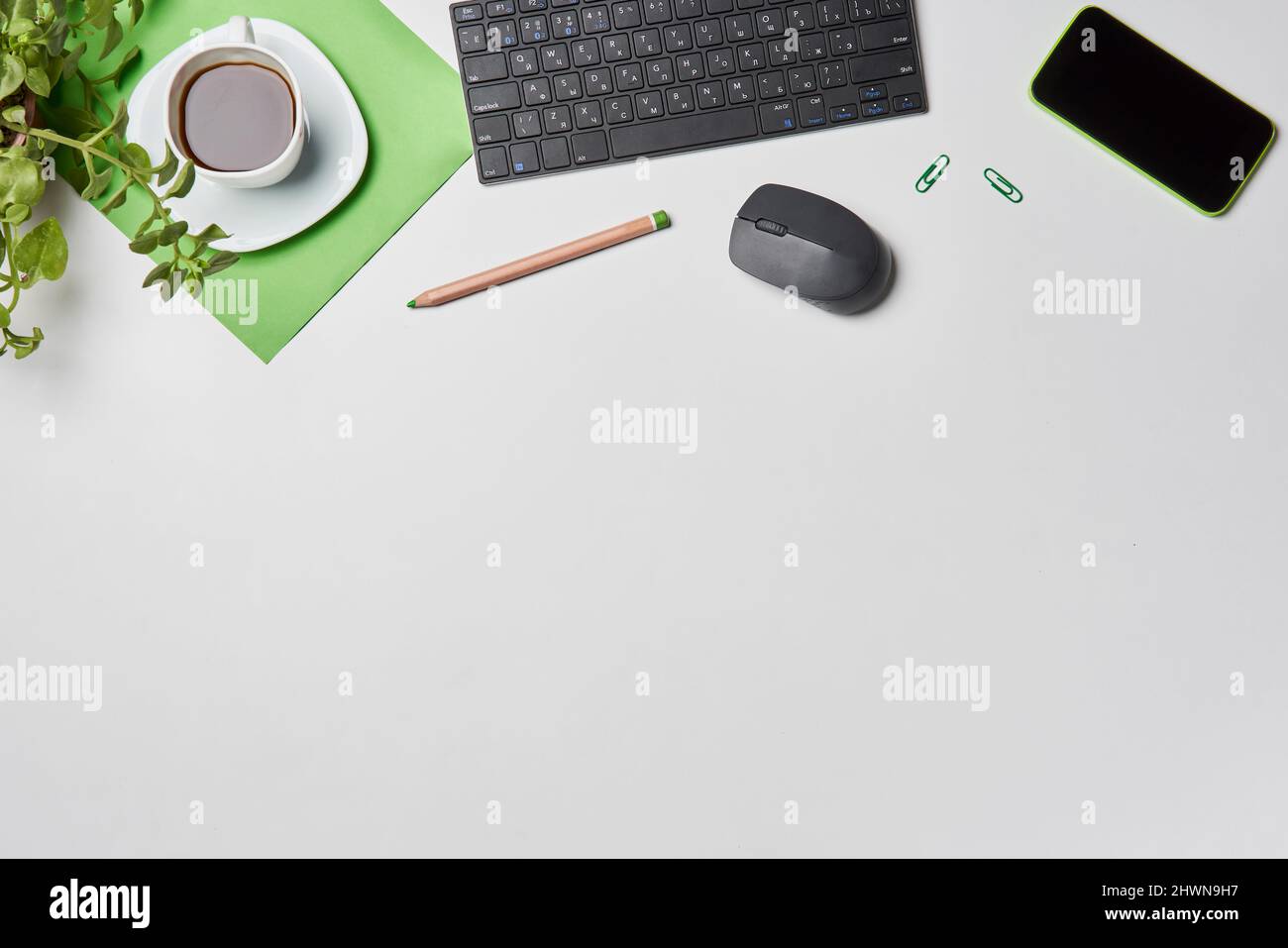 Bright office workspace. Work space with notepad, keyboard, coffee and ...