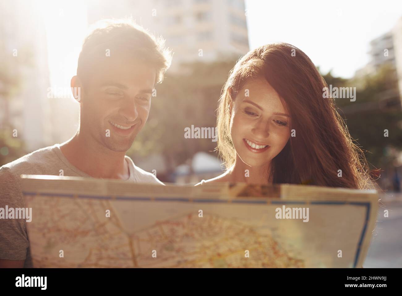 Finding their way around on vacation. Cropped shot of a young couple ...