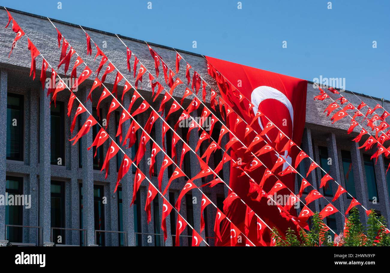 Turkish national flag hang on a pole in open air waving against sky ...