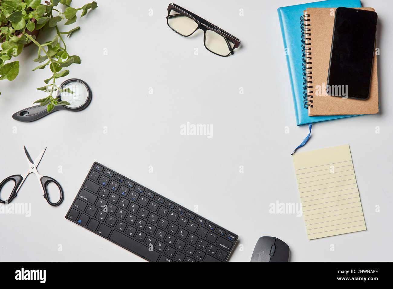 Bright office workspace. Work space with notepad, keyboard, coffee and ...