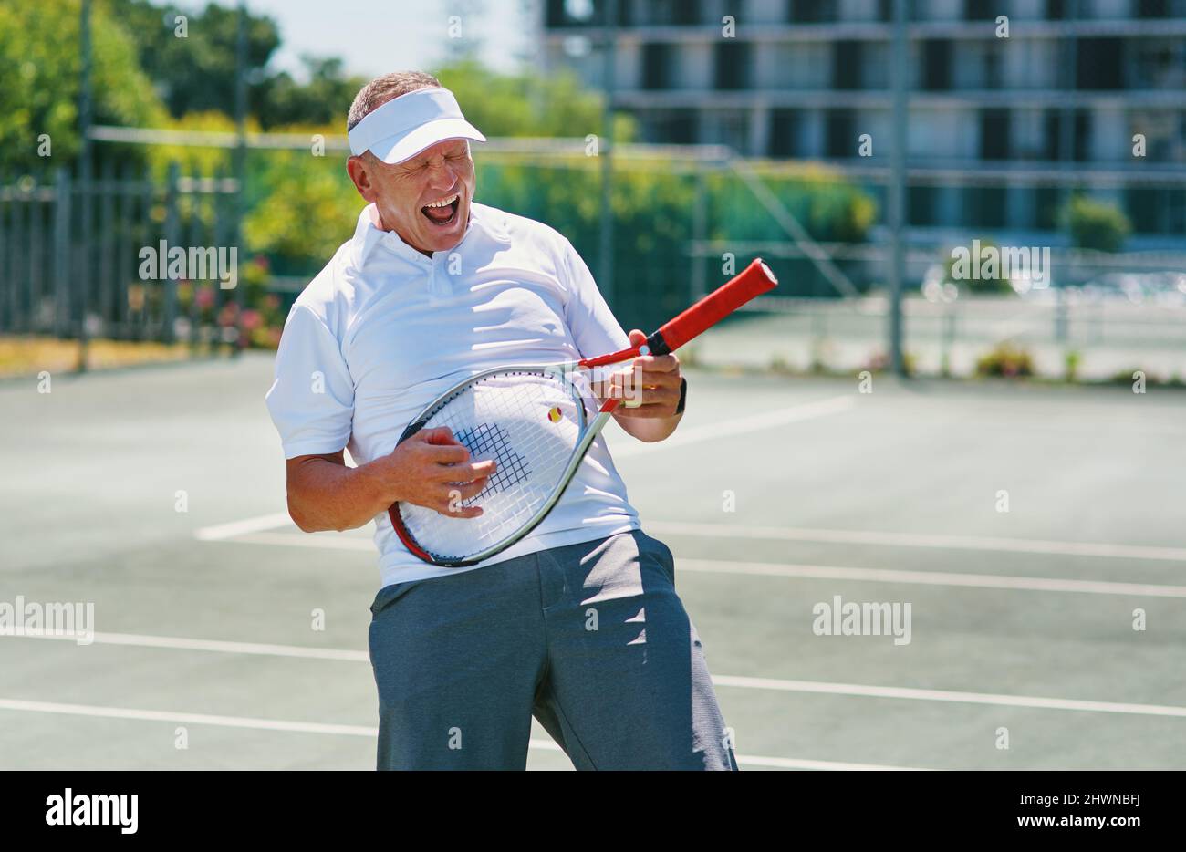 Tennis keeps me young at heart. Cropped shot of a handsome mature man ...