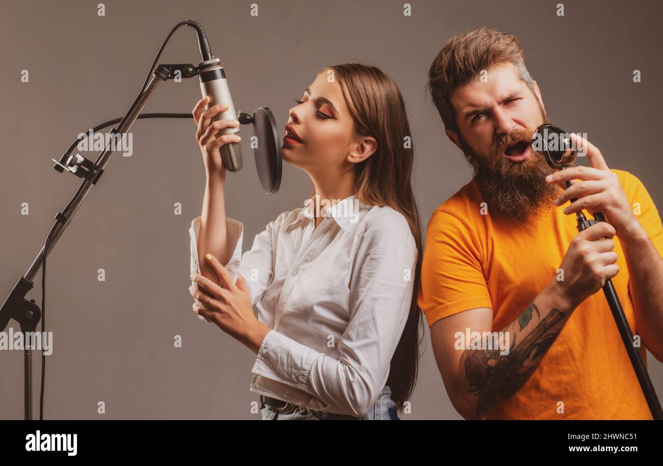 Karaoke singers couple. Woman and man singing with music microphone ...