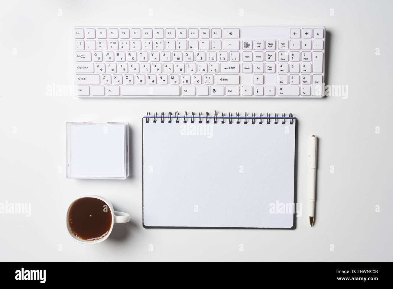 Bright office workspace. Work space with notepad, keyboard, coffee and ...