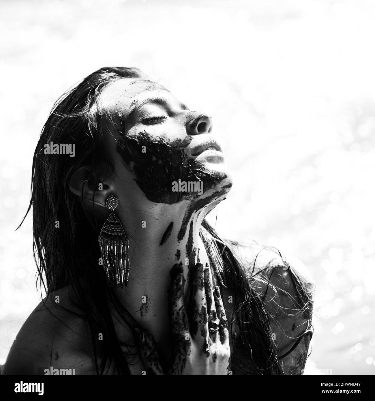 Woman with natural mud mask. Woman relaxing with a charcoal facial mask ...