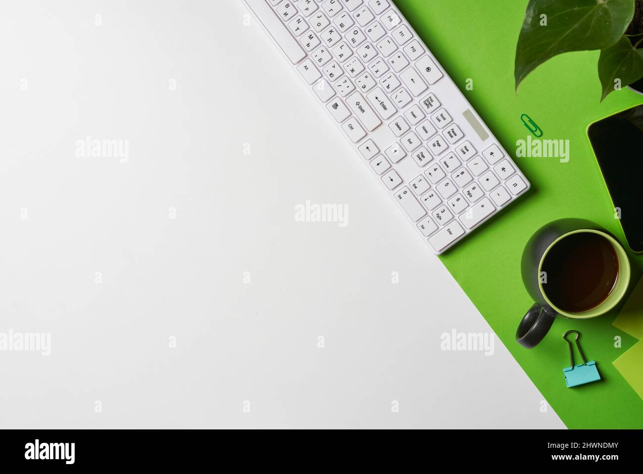 Bright office workspace. Work space with notepad, keyboard, coffee and ...