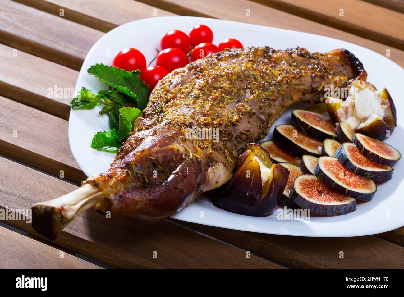 Baked shoulder of mutton with figs, tomatoes, soft cheese Stock Photo ...