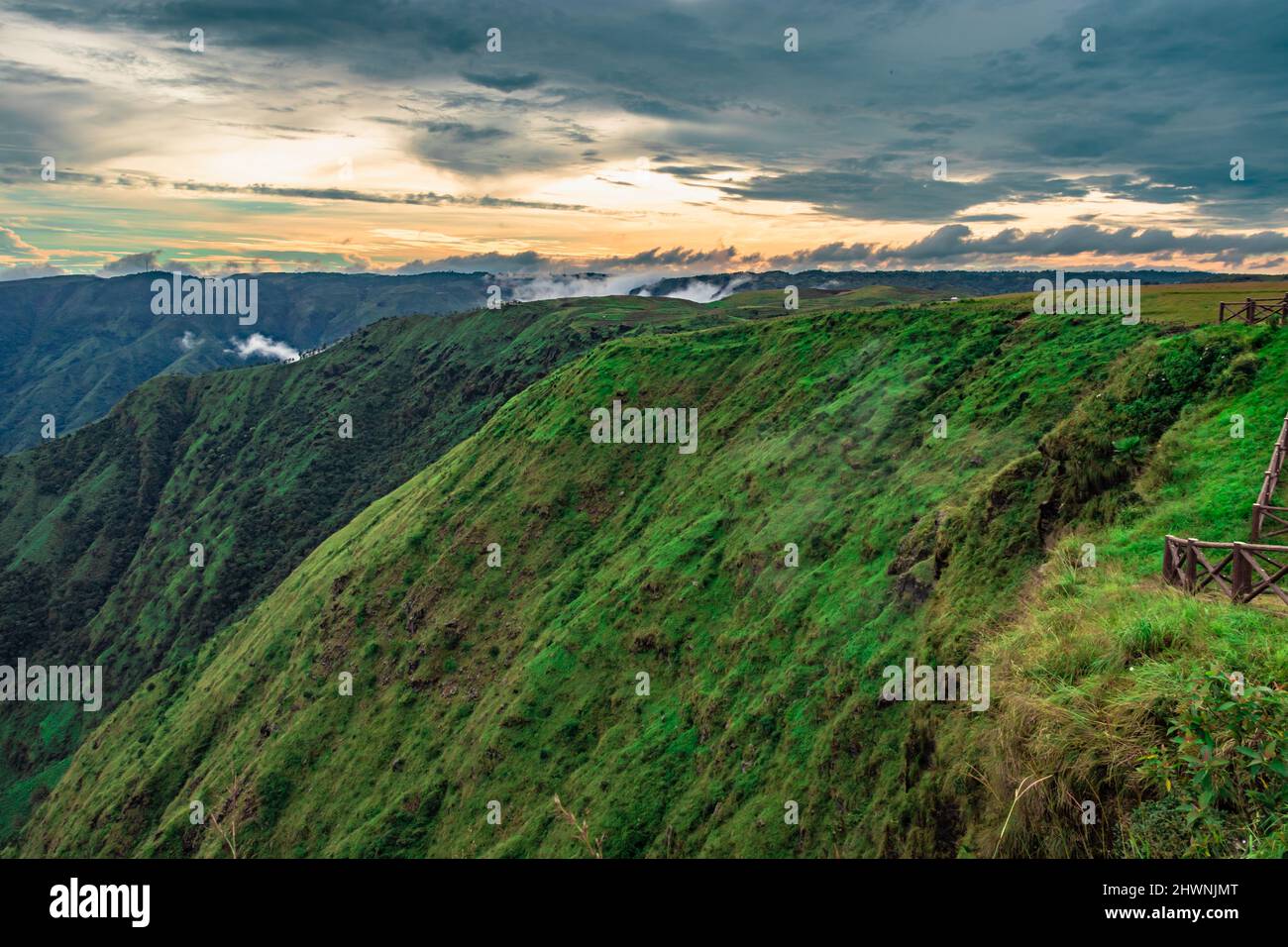 mountain valley covered with green forests and bright blue sky at ...