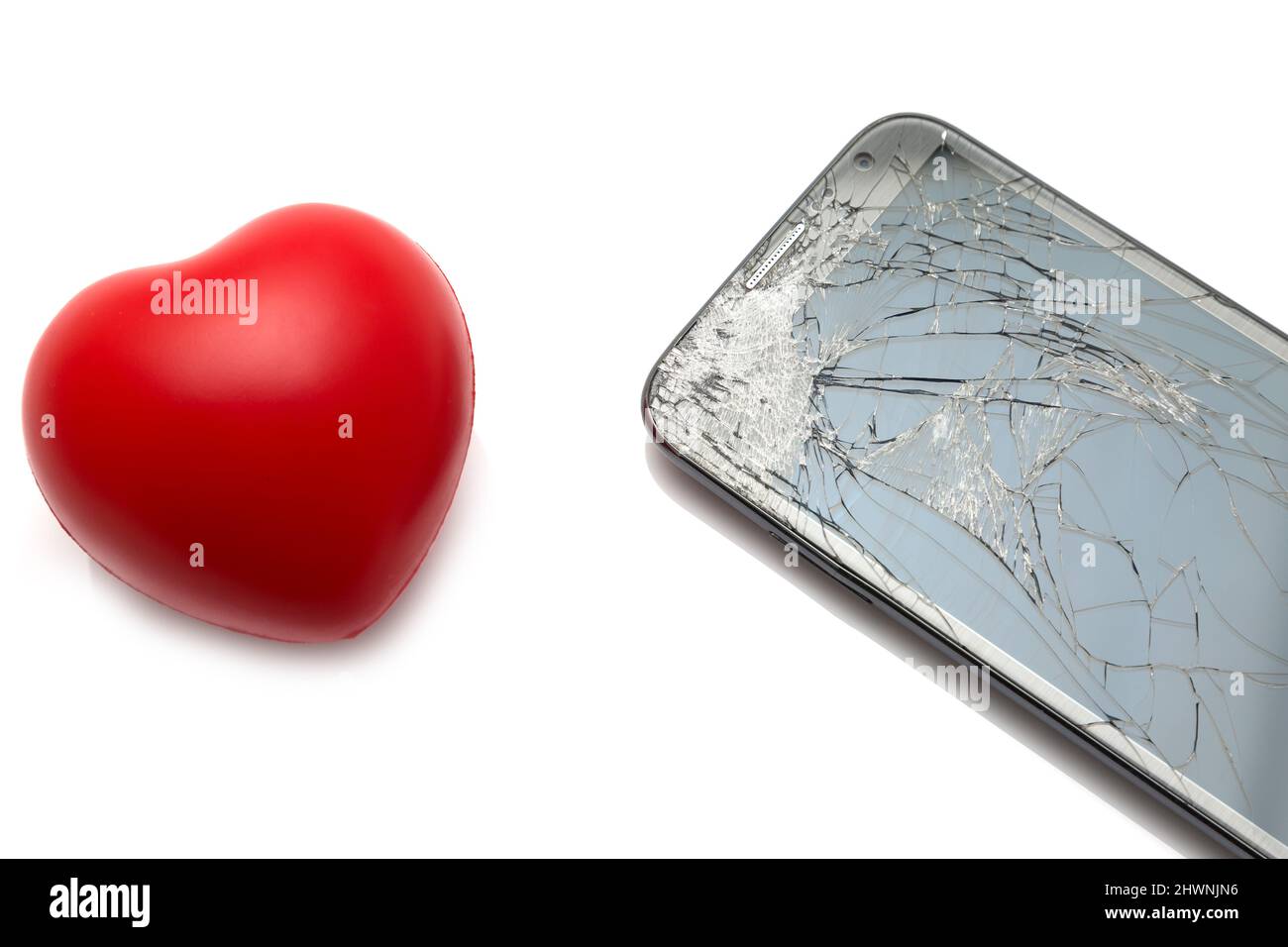 Smartphone with broken screen with red heart isolated on white ...