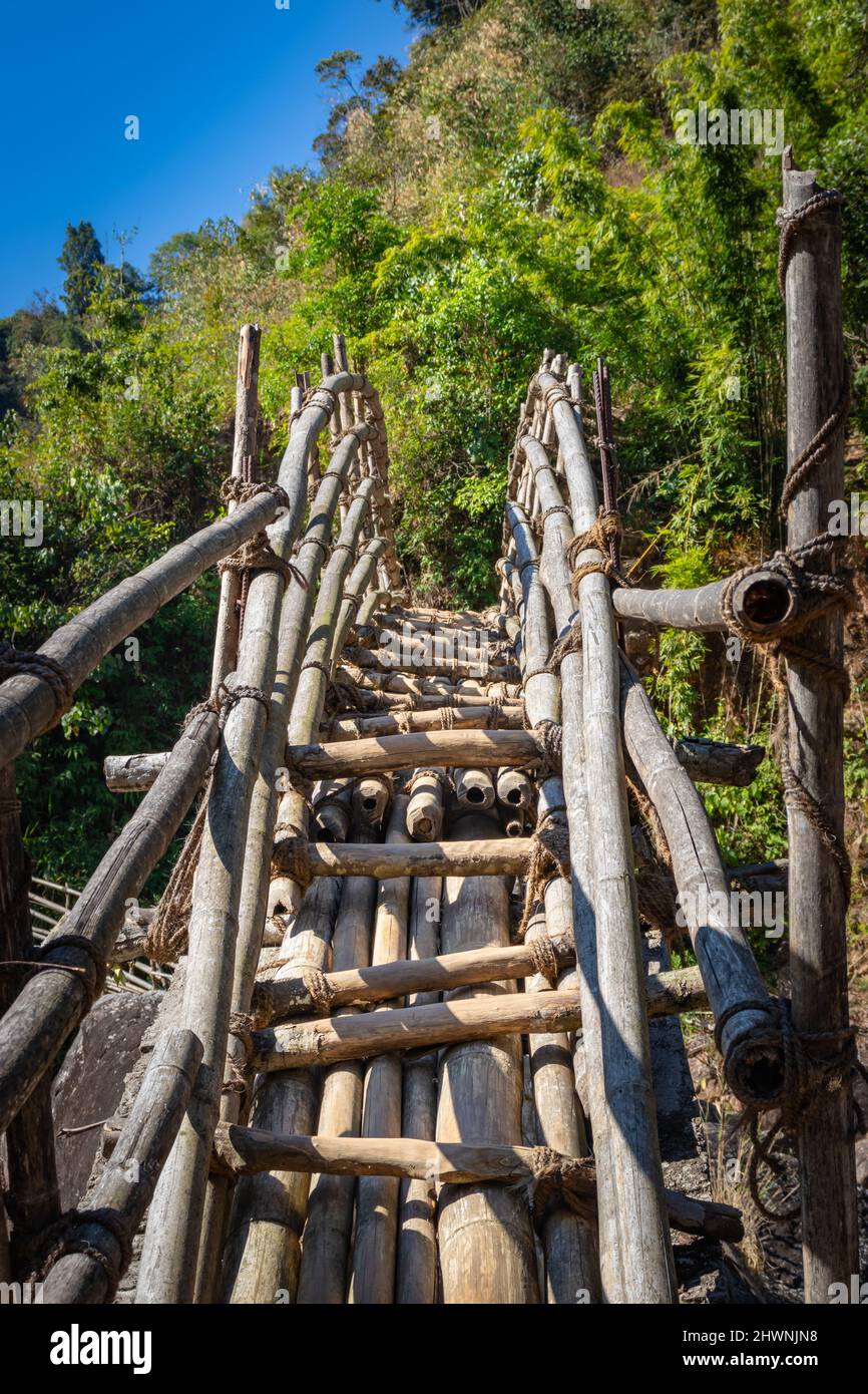 traditional bamboo bridge for crossing river at forest at morning from ...