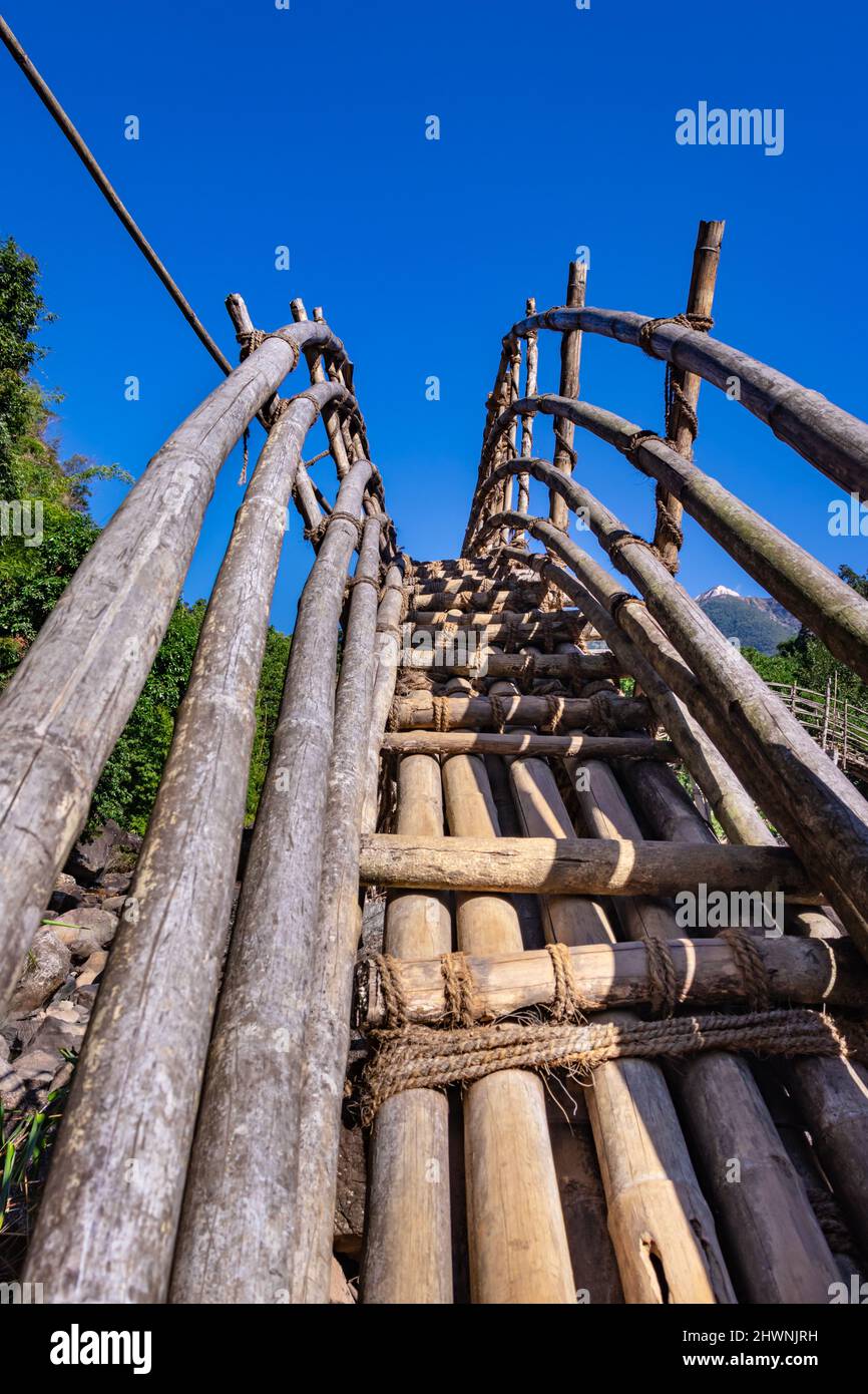 traditional bamboo bridge for crossing river at forest at morning from ...