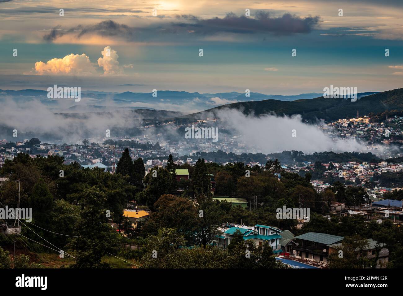 downtown city view with dramatic cloudy sky at evening from mountain ...
