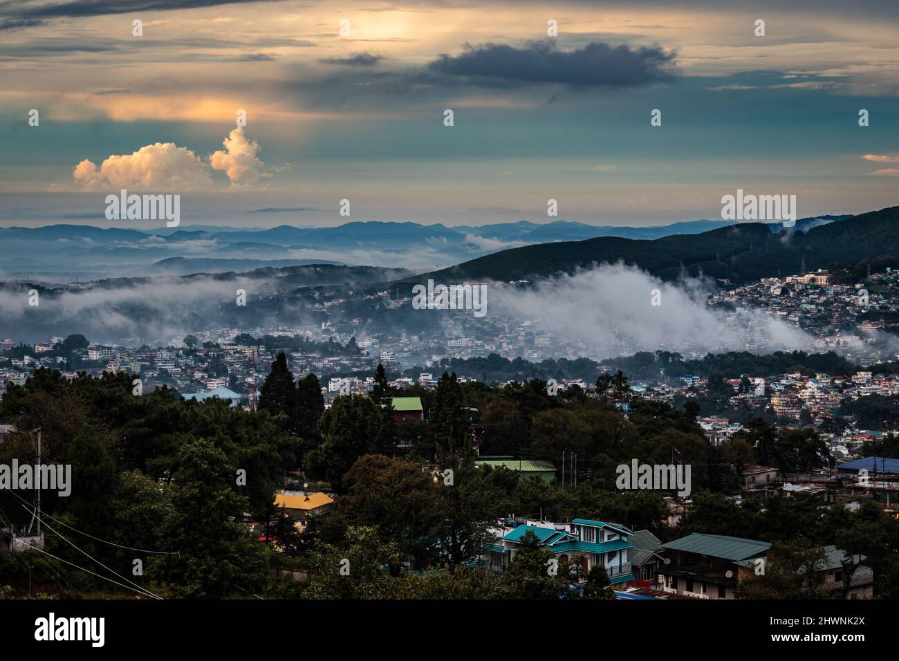downtown city view with dramatic cloudy sky at evening from mountain ...
