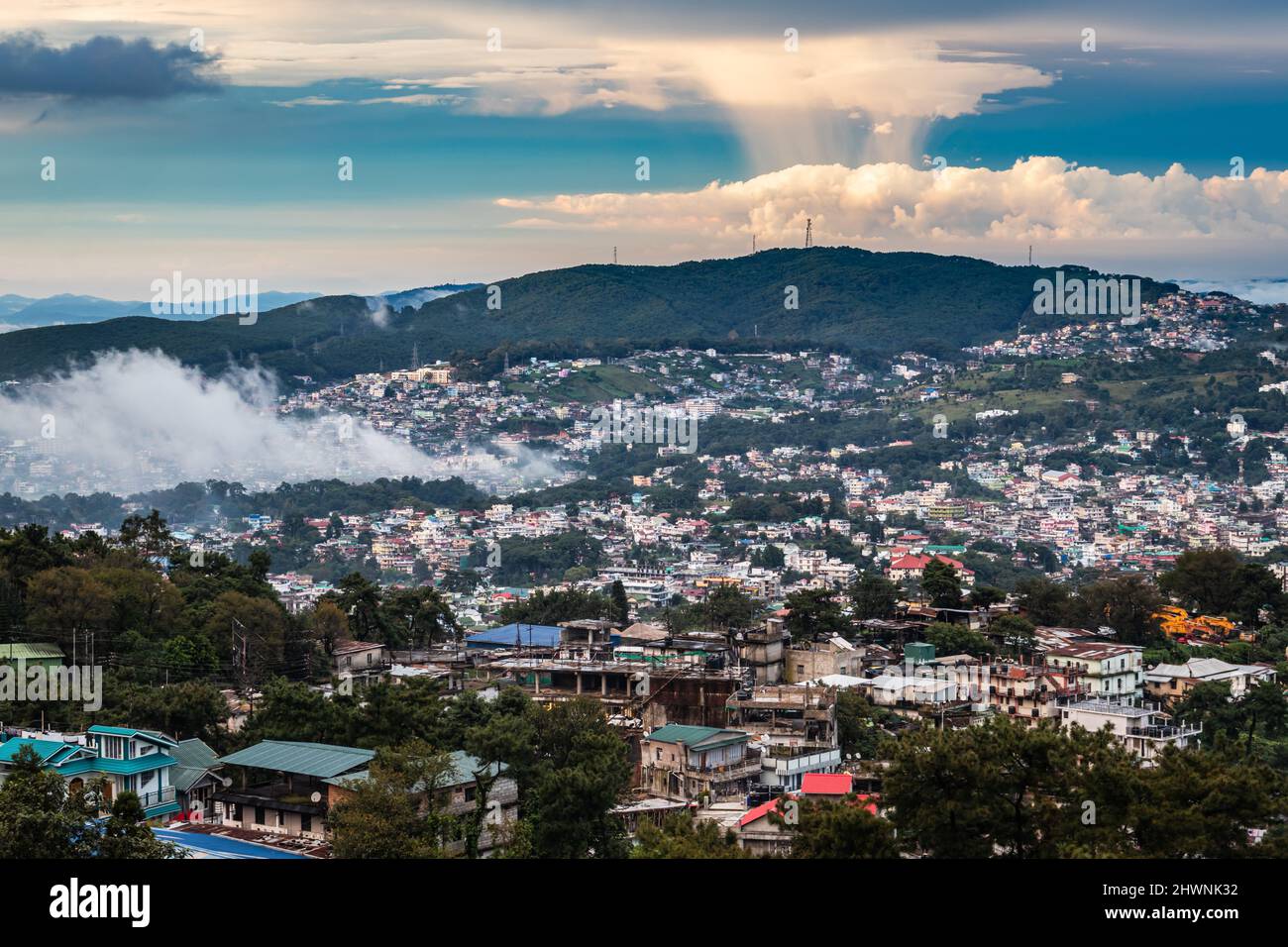 downtown city view with dramatic cloudy sky at evening from mountain ...