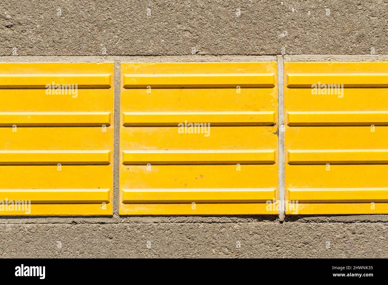 Yellow guiding block brick floor pattern Stock Photo - Alamy