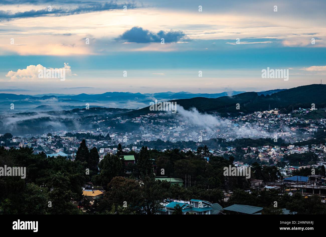 downtown city view with dramatic cloudy sky at evening from mountain ...