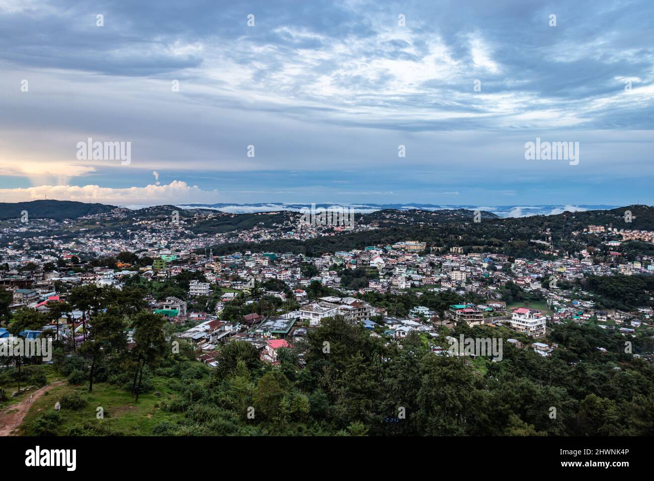 downtown city view with dramatic cloudy sky at evening from mountain ...