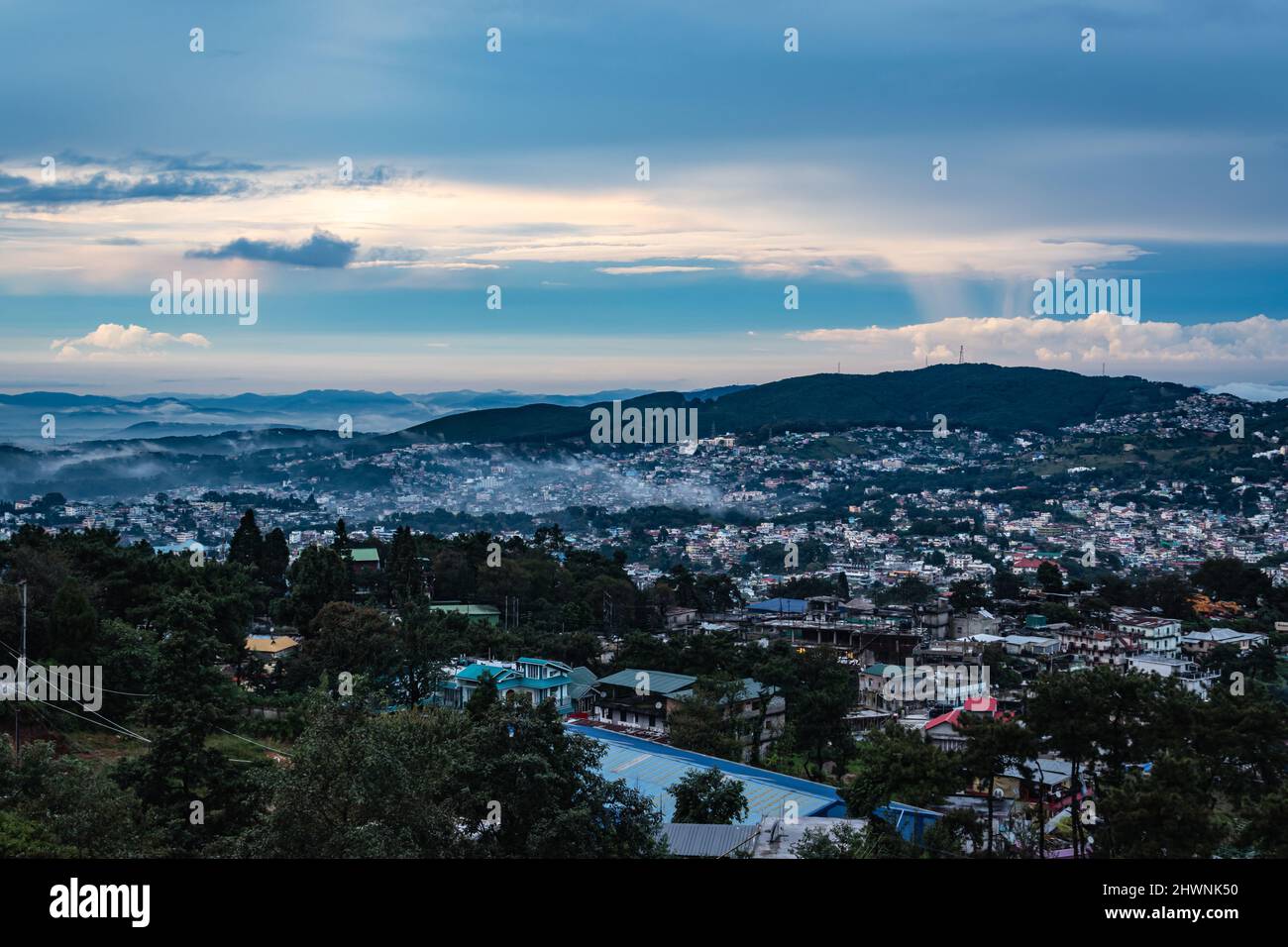 downtown city view with dramatic cloudy sky at evening from mountain ...