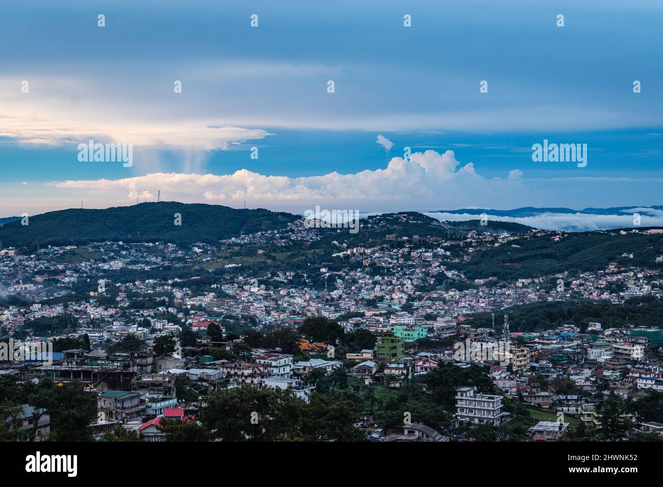 downtown city view with dramatic cloudy sky at evening from mountain ...