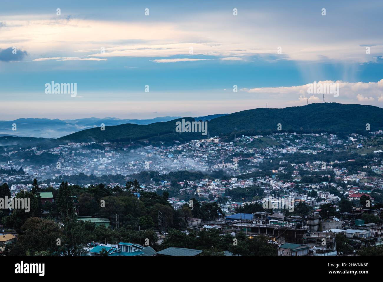 downtown city view with dramatic cloudy sky at evening from mountain ...