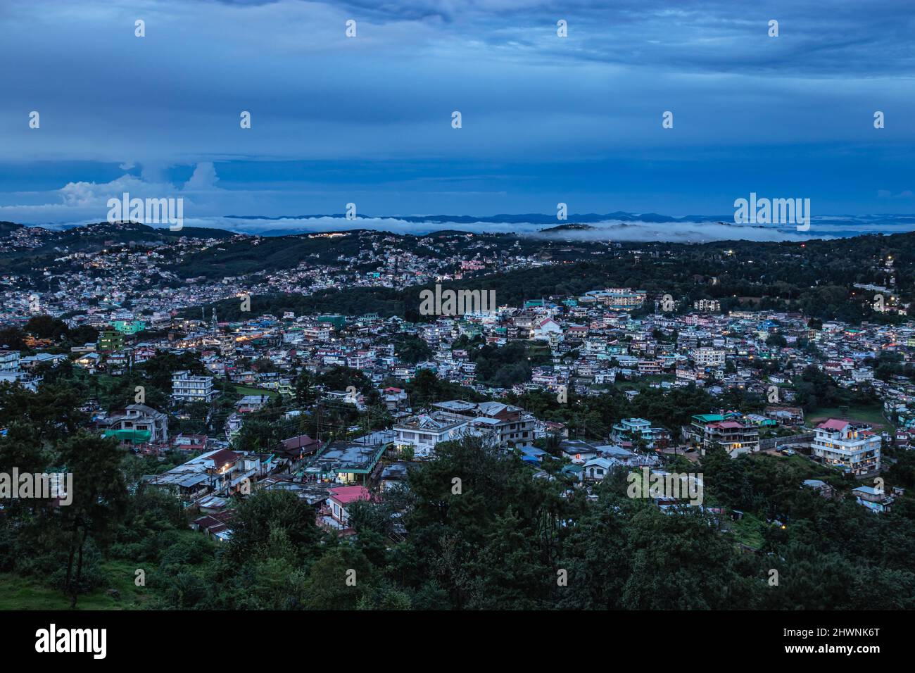 downtown city view with dramatic cloudy sky at evening from mountain ...