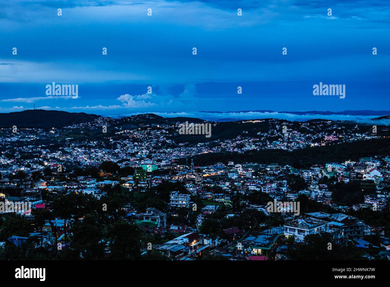 downtown city night view with lighting and dramatic cloudy sky at ...
