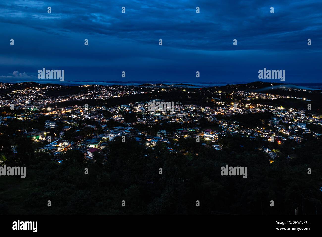 downtown city night view with lighting and dramatic cloudy sky at ...