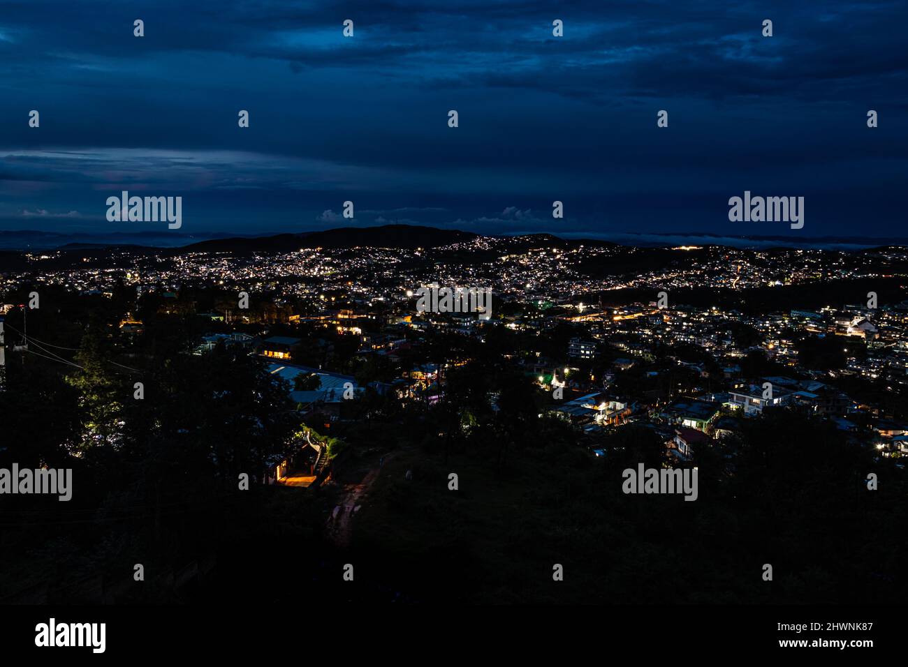 downtown city night view with lighting and dramatic cloudy sky at ...