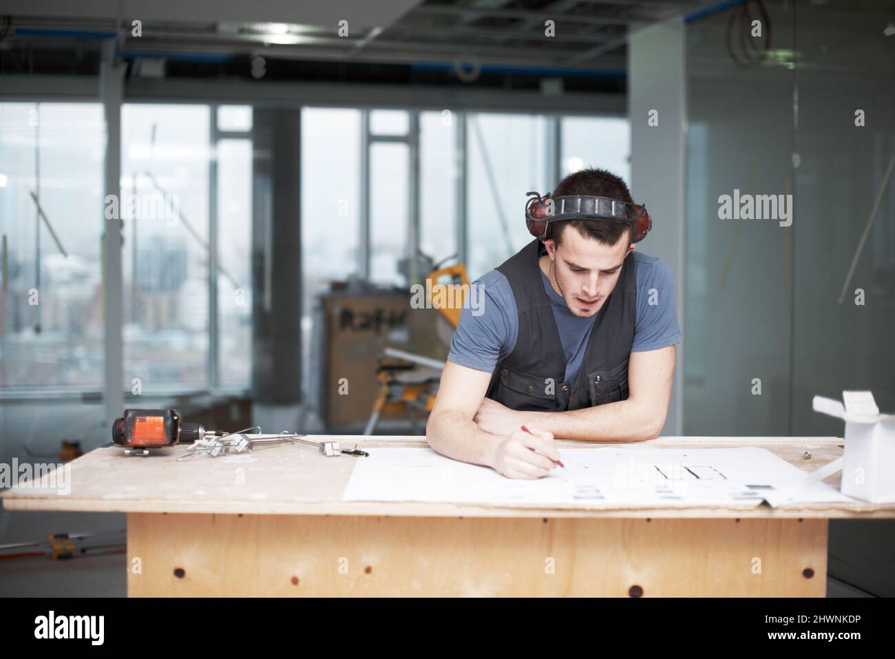 Working to create a precise design. Young architect working on his ...