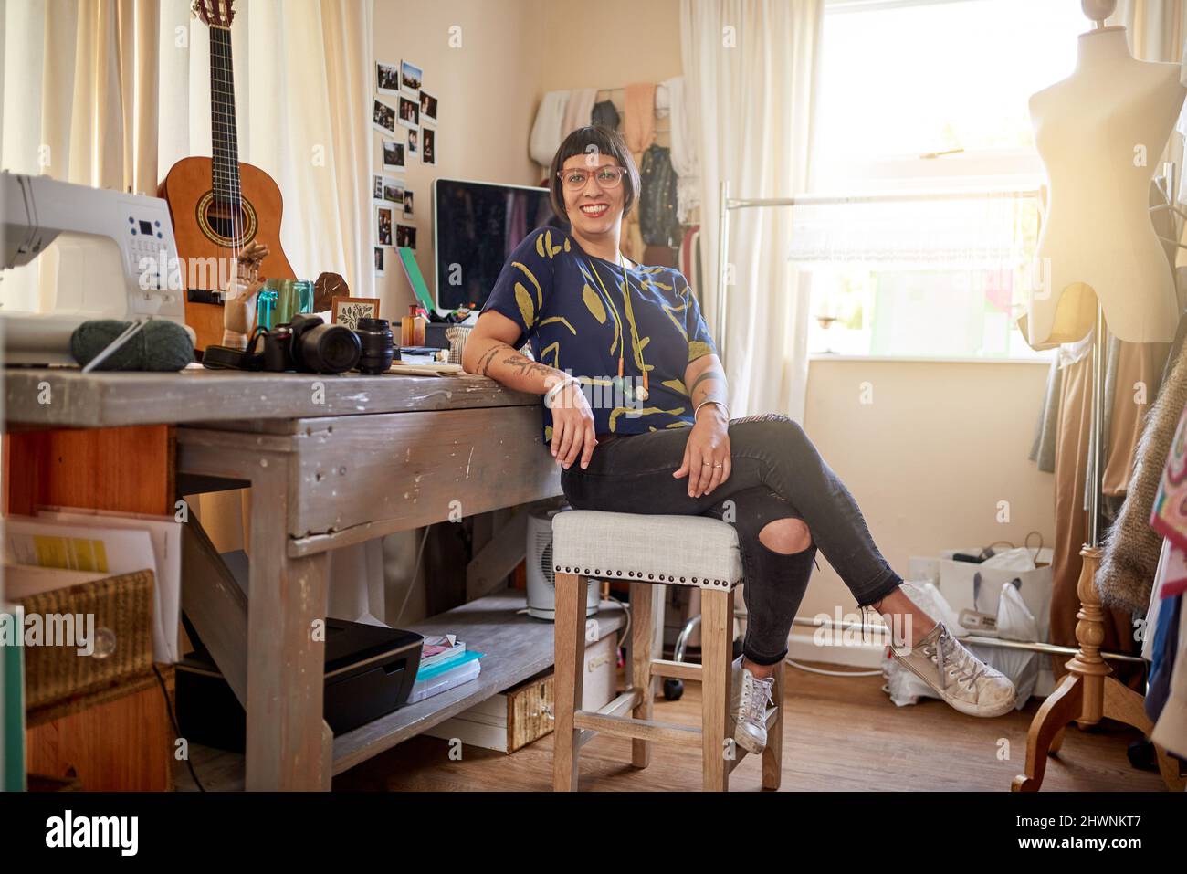 Its my creative space. Portrait of a stylish young designer sitting in ...