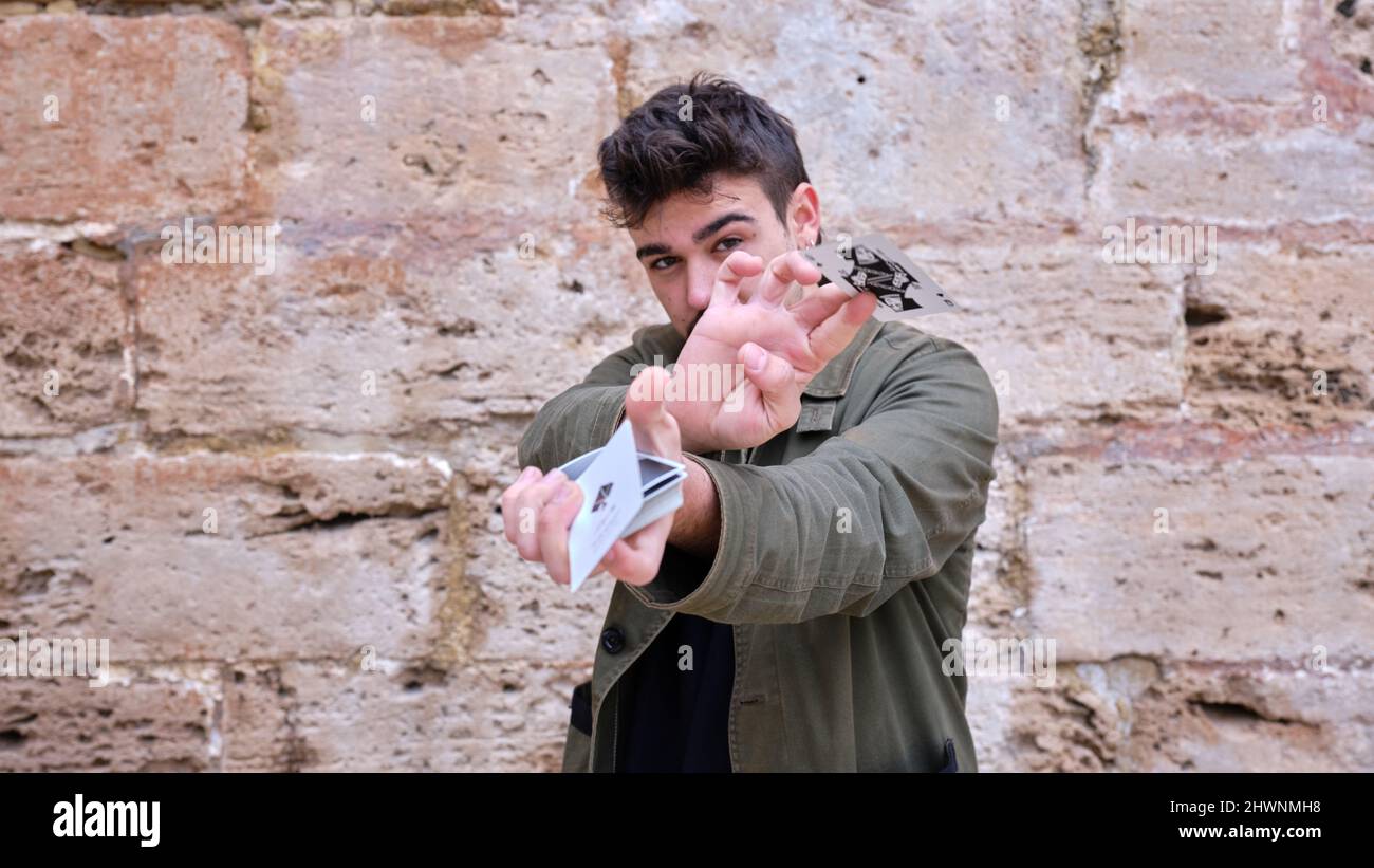 Portrait of a street magician performing tricks with cards Stock Photo ...